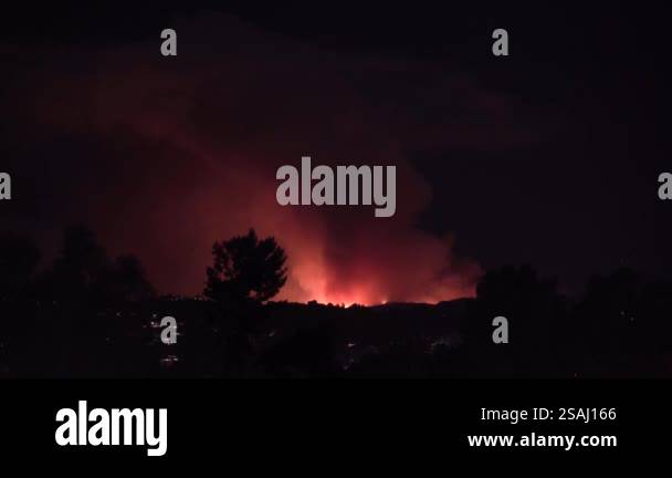 A massive wildfire burning on the hills near Palisades, California ...