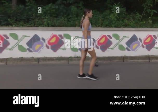 Young athletic woman cooling down after an intense workout. Shes taking ...