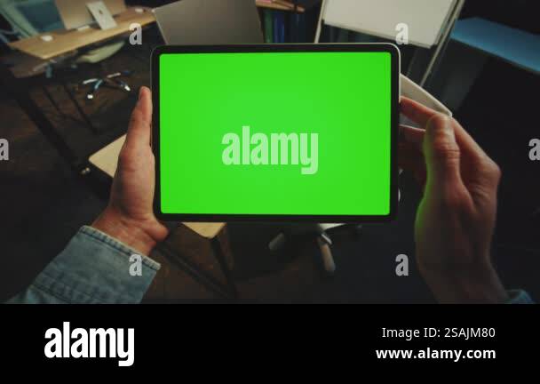 Close up hands man holding scrolling a tablet computer with a ...