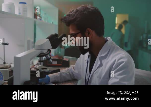 Portrait smiling man scientist with glasses and protective gloves ...