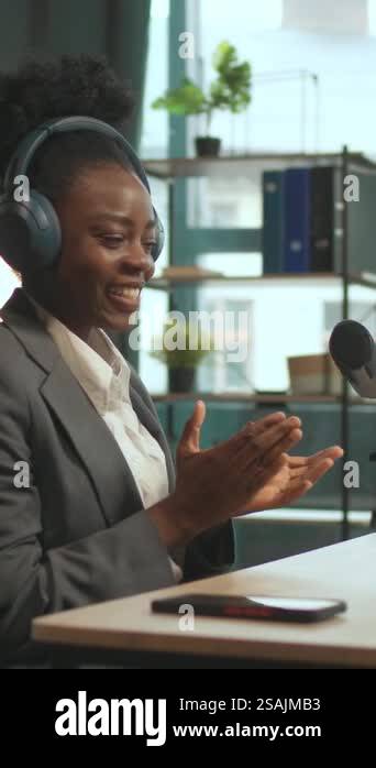 360 degree shot of happy African American female radio presenter ...