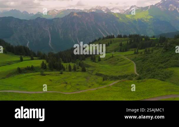 Cyclist on gravel road amidst stunning alpine scenery of Fellhorn and ...