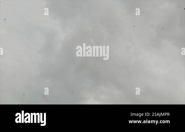 Sky view with weather conditions that are light rain and dark clouds ...