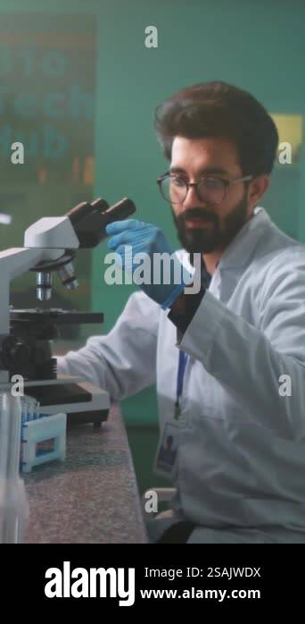 Slow motion young man scientist with glasses and protective gloves ...