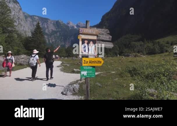 June 15, 2023. Germany, Salet, Schoenau am Koenigsee. Tourists follow ...