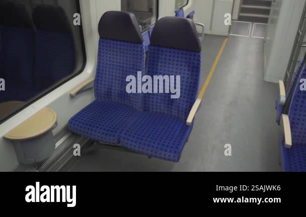 Empty train interior at night, featuring blue ergonomic seats in modern ...