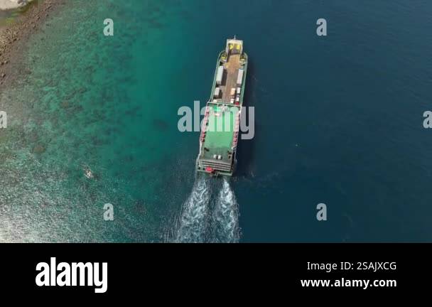 Cinematic aerial perspective of Roll-on/Roll-off ferry docking at ...