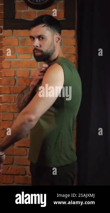 handsome sport man. man leaning against brick wall. muscular guy. smile ...