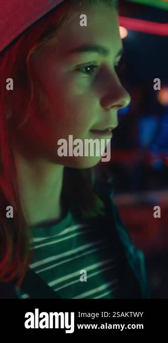 Vertical closeup of face of young Caucasian kid with long hair, in ...