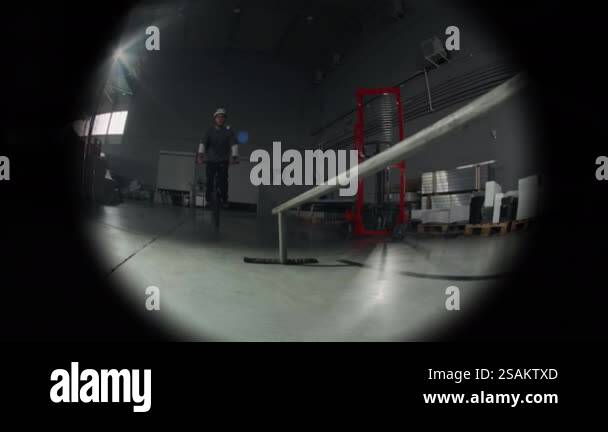 Fisheye slowmo shot of young male BMX rider in protective helmet ...