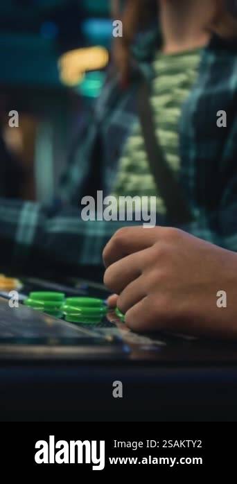 Vertical closeup of hands of anonymous young kids playing video game ...