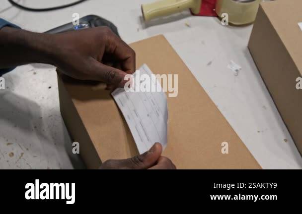 Closeup of hands of unrecognizable black male factory manager or ...