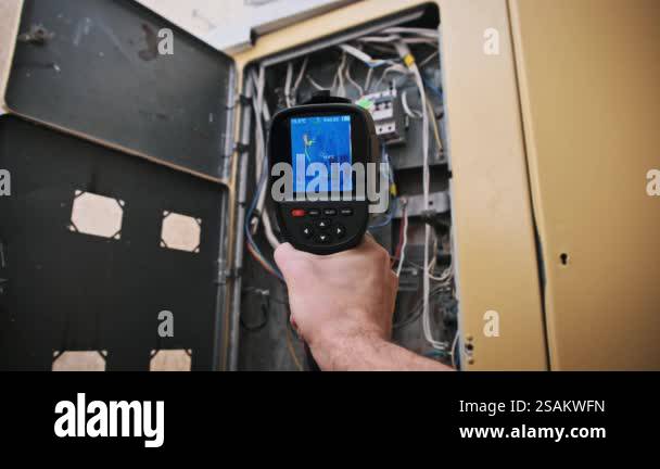 Handheld thermal imager used to scan interior of an electrical ...