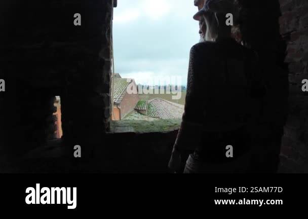 Tourist is looking out of the windows of the medieval Dozza Castle in ...