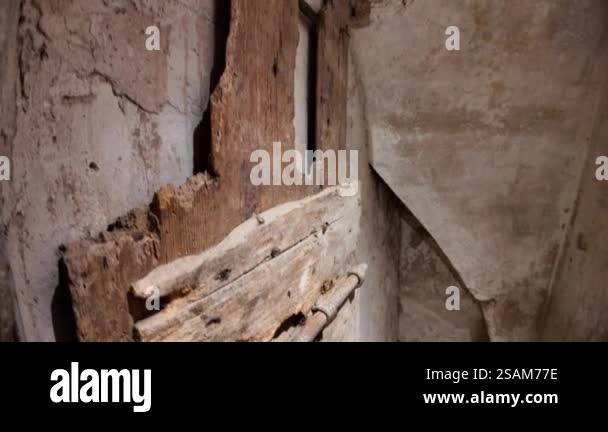 Metal ladder leads down into a dark, subterranean passage within the ...