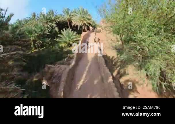Aerial view capturing a tourist walking along the ancient farms of ...