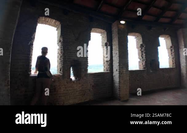 Tourist is looking out of the windows of the medieval Dozza Castle in ...