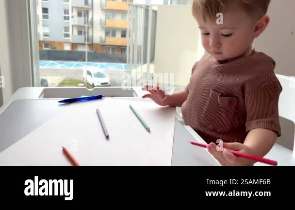 A one-and-a-half-year-old child is enthusiastically playing at the ...
