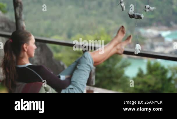 Woman sitting on a bench with feet propped up. Female relax outdoor on ...