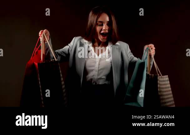 Woman enjoying shopping in stylish attire at a mall while holding ...