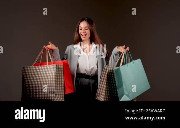 Woman enjoying shopping in stylish attire at a mall while holding ...