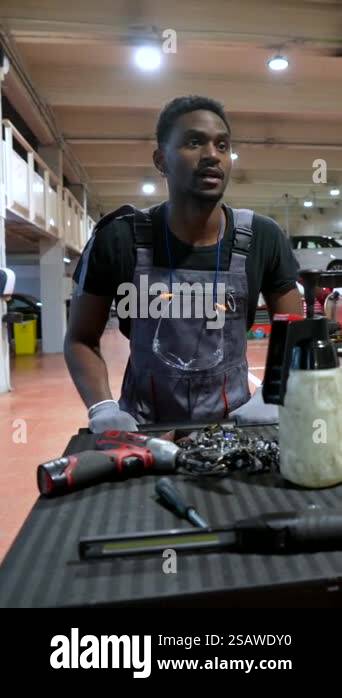 Mechanic explaining car repair techniques to a trainee in a well ...