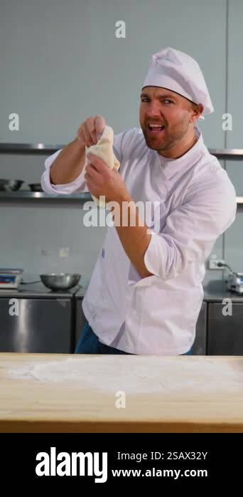 Chef pretends to sing with dough. A humorous chef in a white uniform ...
