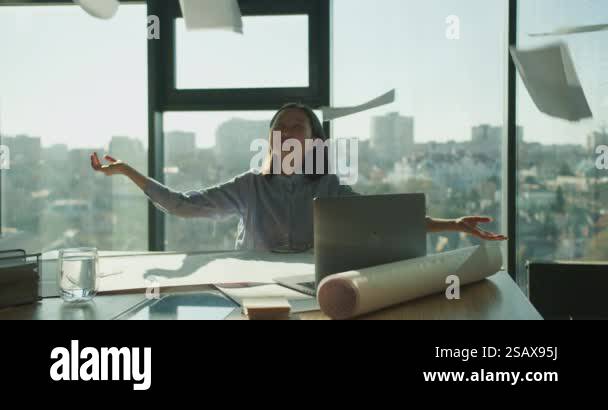 A joyful architect sits in a modern, light-filled office with large ...