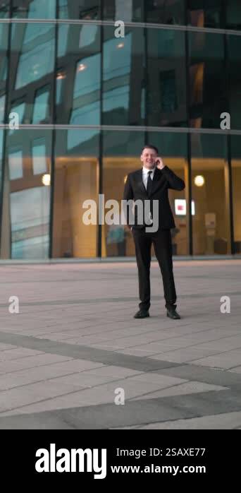 Funny joke. Young businessman have a smartphone talking. Goof stupid ...