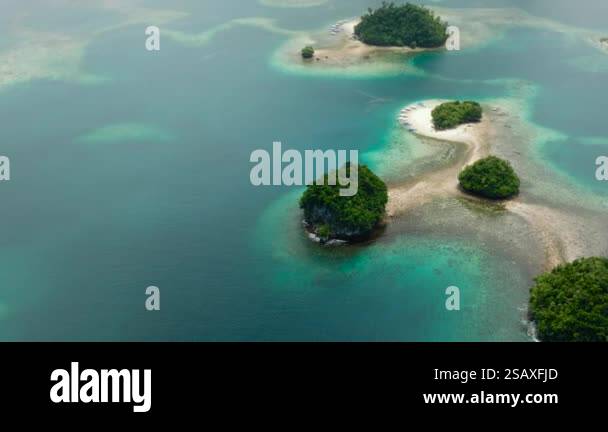 Cluster of tropical islets with turquoise ocean water and corals ...
