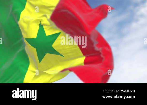 Close-up of Senegal national flag waving on a clear day. Tricolor with ...