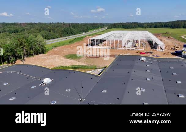 Aerial view of a construction site with a large building framework and ...