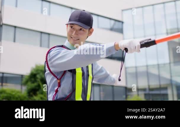 Asian traffic controller directing traffic Stock Video Footage - Alamy