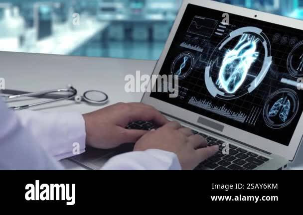 Close up of doctor typing and looking at laptop with human heart ...