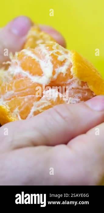 Peeling Orange. Female hands peeling orange fruit. Woman removing ...