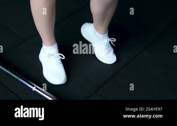 circular foot movements. stretch the joints of the legs Young woman ...