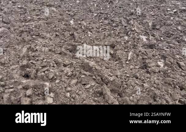 A close up of dry, cracked soil showing the rough texture and arid ...