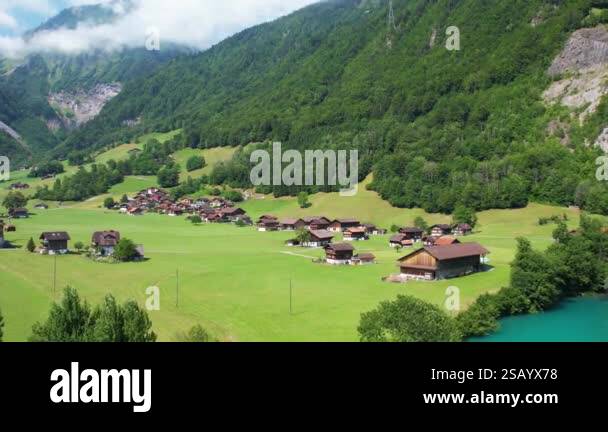 Drone footage of turquoise clear lake Lungern or Lungerersee in ...
