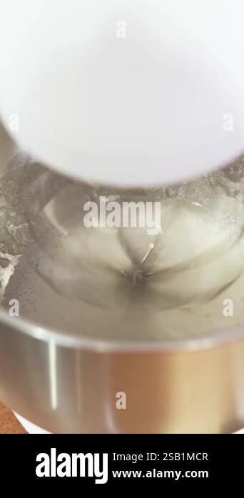 A closeup view of an electric mixer efficiently whipping various ...