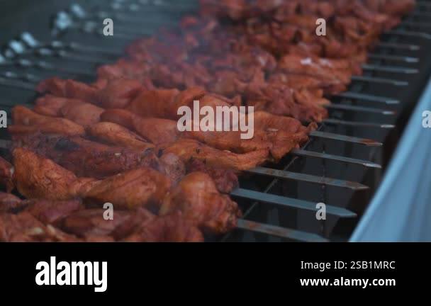 Skewers of delectable marinated meat are grilling perfectly, capturing ...