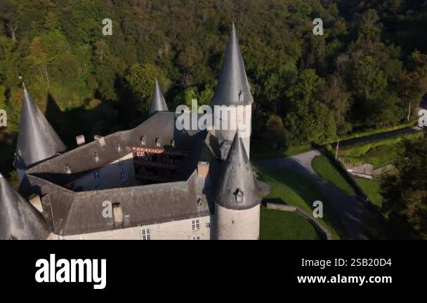 Discover the majestic Veves Castle surrounded by vibrant trees and ...