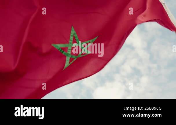 The Moroccan flag waves proudly against a cloudy sky. This stock video ...