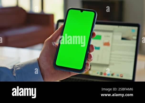 Unknown man holding mockup smartphone sitting at desk. Unrecognizable ...