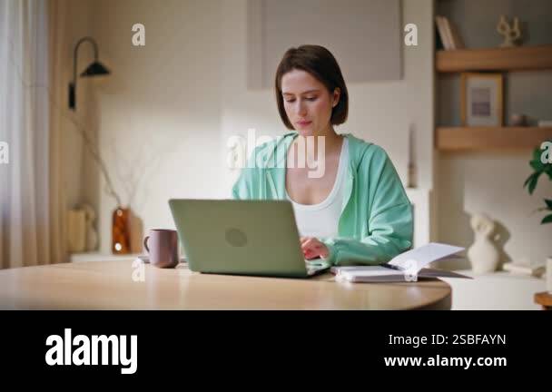 Relaxed lady surfing laptop making online research at modern apartment ...