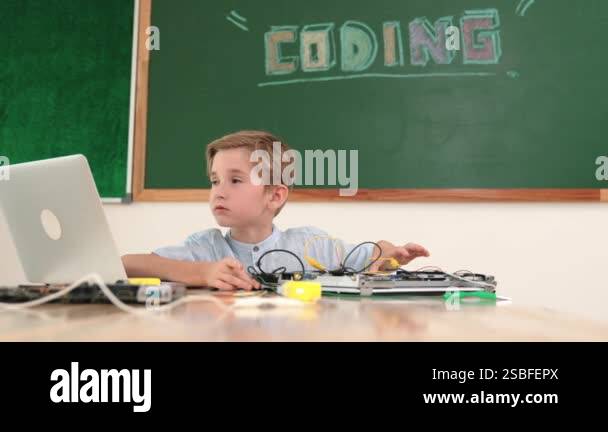 Student working on electronic board while sitting at Stem class with ...