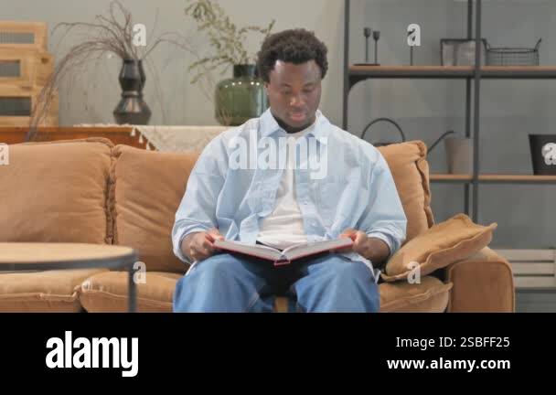 African man sitting reading book Stock Videos & Footage - HD and 4K ...