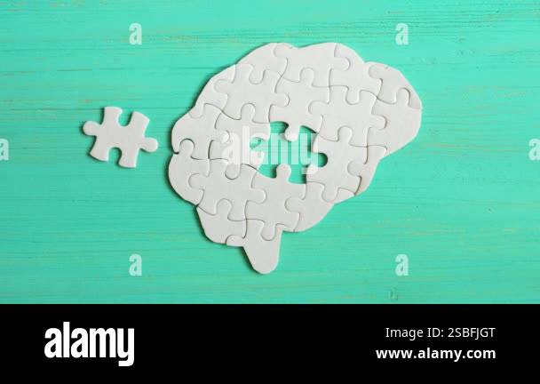 Close-up of a hand taking the final jigsaw puzzle piece to insert into ...