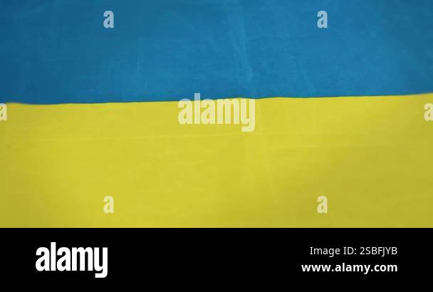 A vibrant blue and yellow flag dances in the wind, symbolizing unity ...