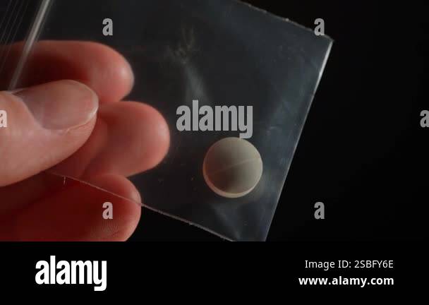 Hard drugs addictive person holding oxi opioid pill drug that he ...