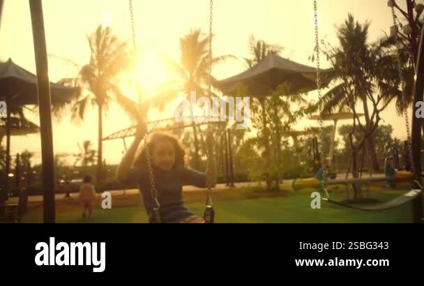 Child happy laughing swings on a swing in the park little boy, on a ...
